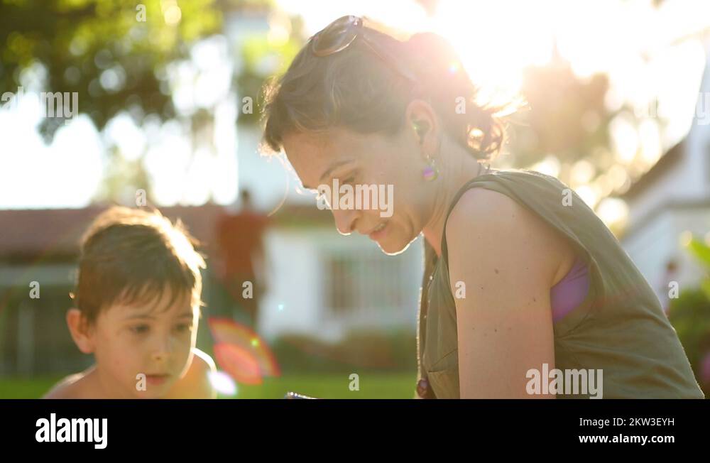 Mom reading a story to her son Child listening to his mother telling ...