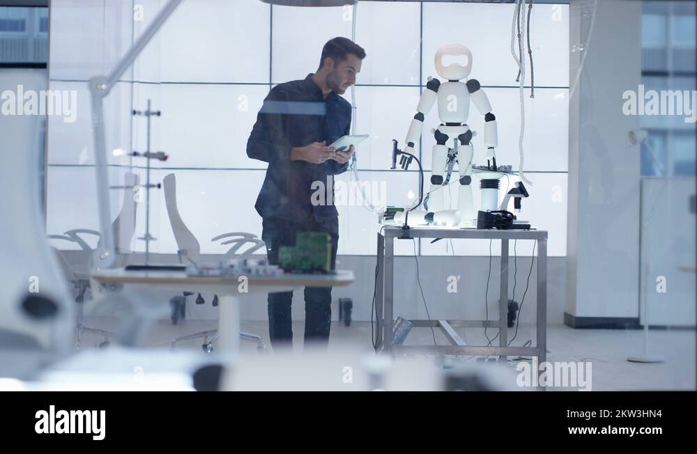 4K Technical engineers working on construction of automated robot in ...