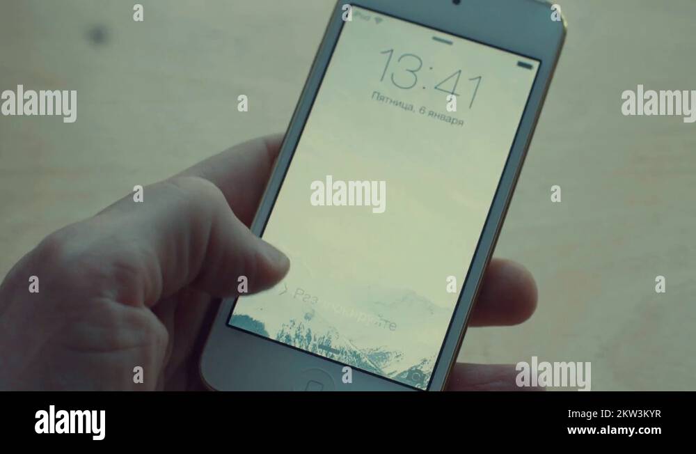 Man hand scrolling photos in smartphone. Pictures of winter village ...