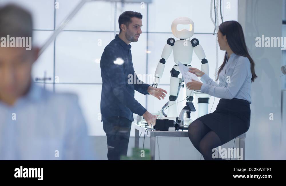 4K Technical design team collaborating on construction of robot in ...