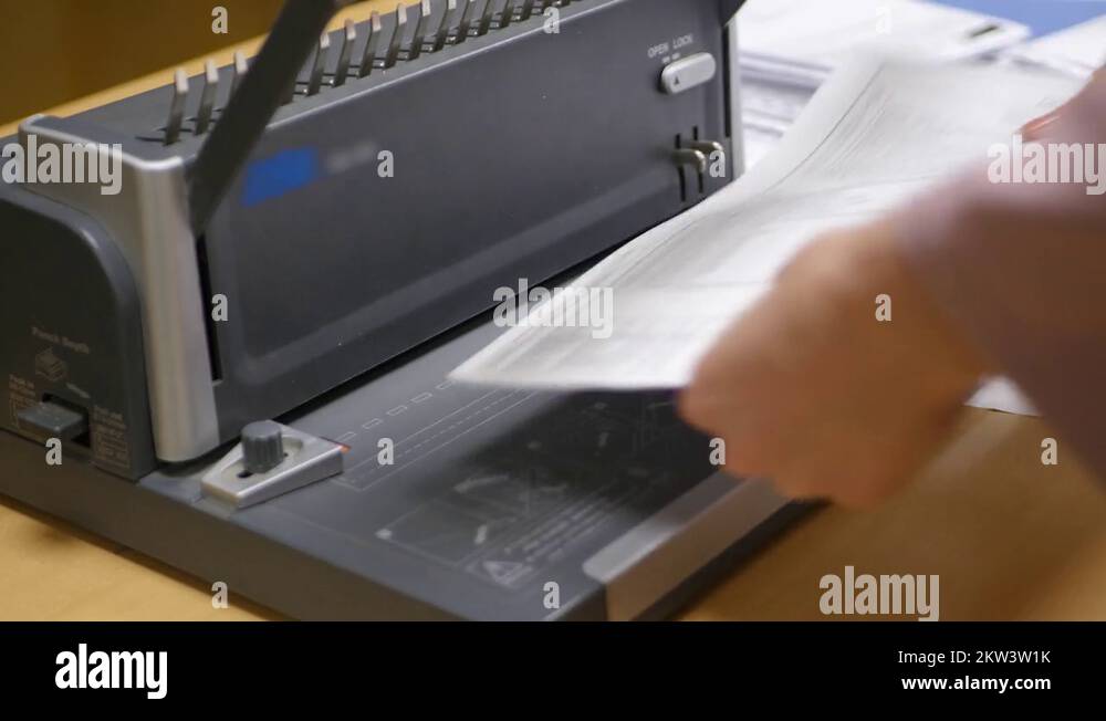 stitch up albums with drawings on a special machine, make holes in the ...