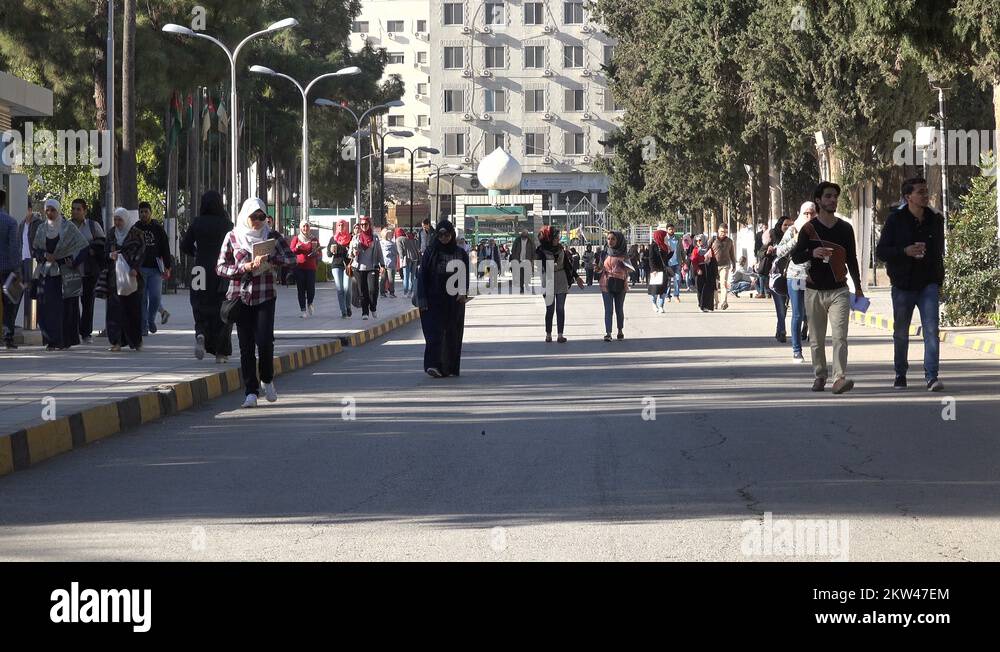 Students walk across the campus of the University of Jordan in Amman ...