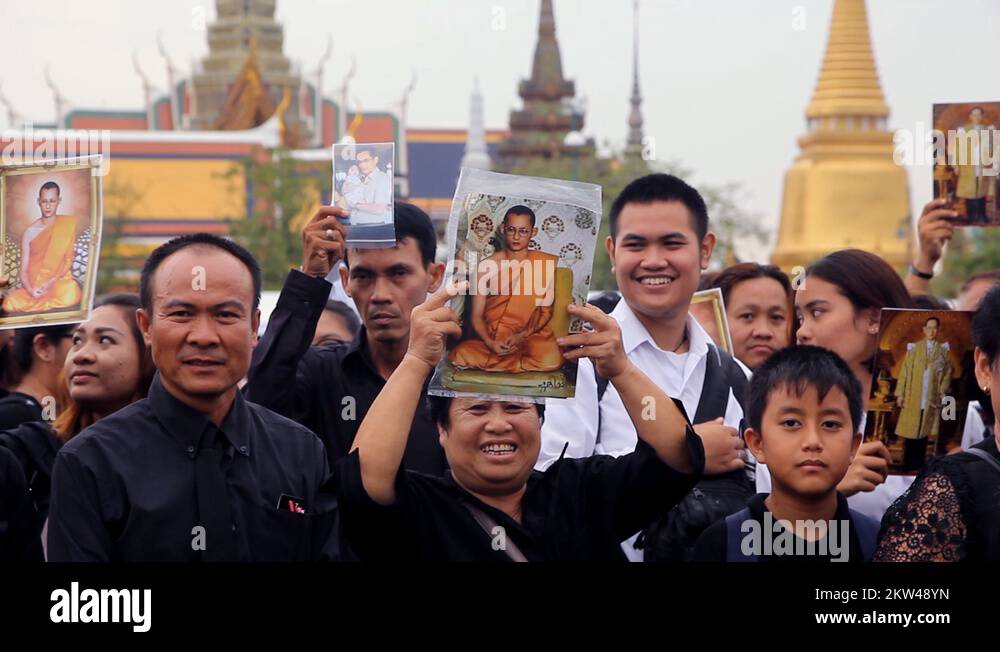 People holds a portrait of king Bhumibol Adulyadej outside the Grand ...