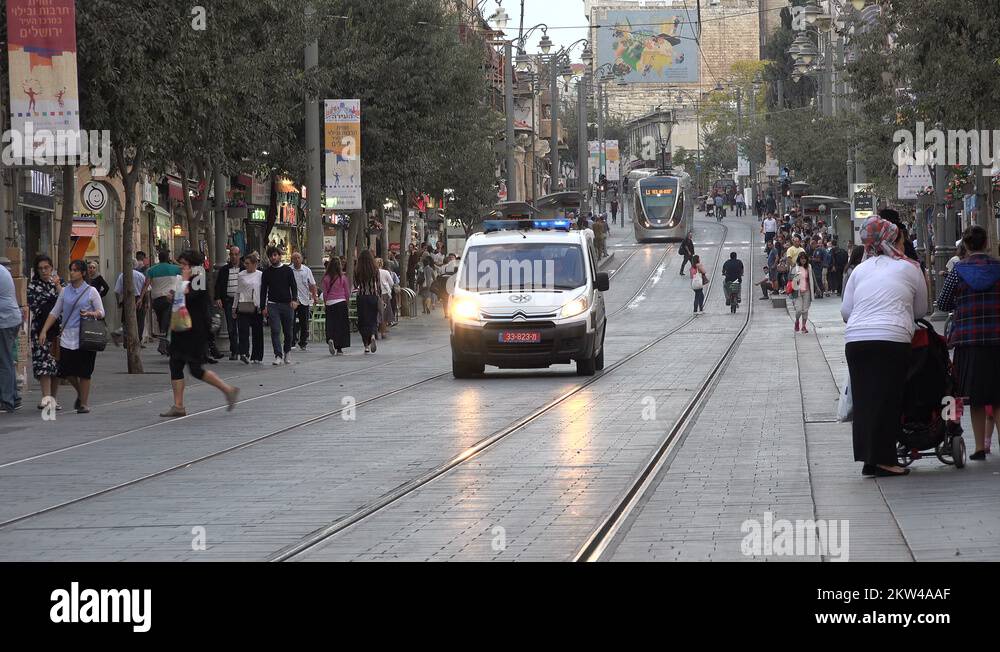 Police vehicle and tram in busy Jaffa street in Jerusalem, Israel Stock ...