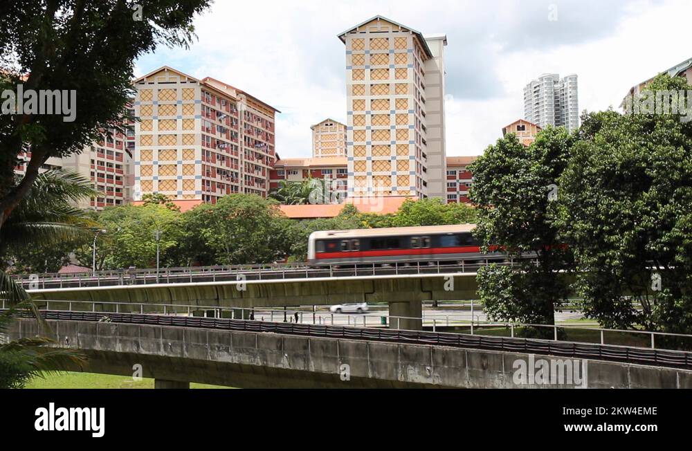 Singapore. Urban MRT train passes in front of HDB block Stock Video ...