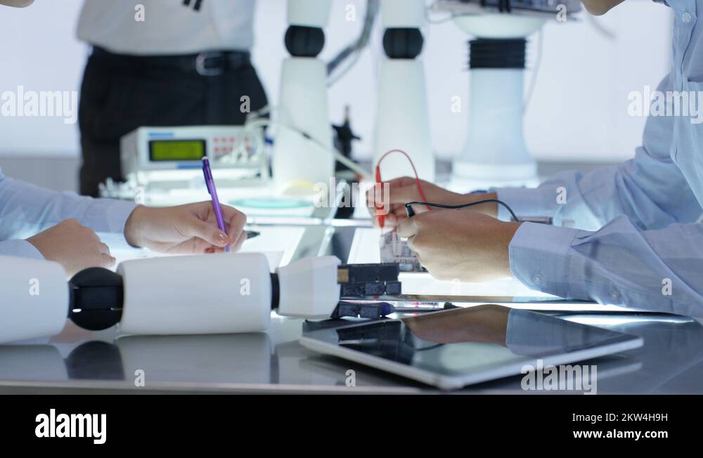 4K Technical design team collaborating on construction of robot in modern lab Stock Video ...