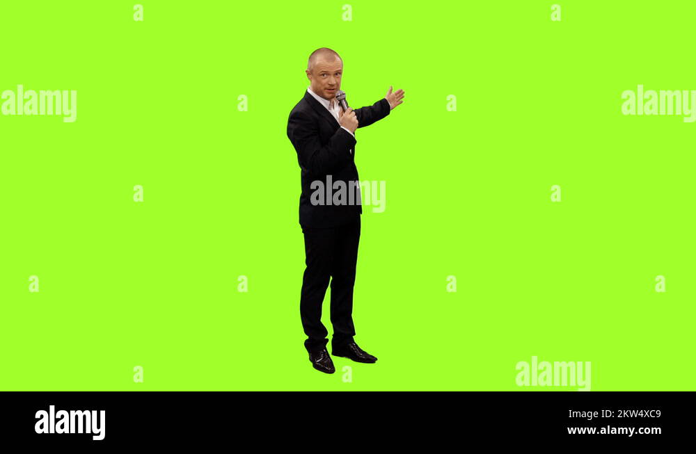 Tv reporter speaking and pointing something on green screen background ...