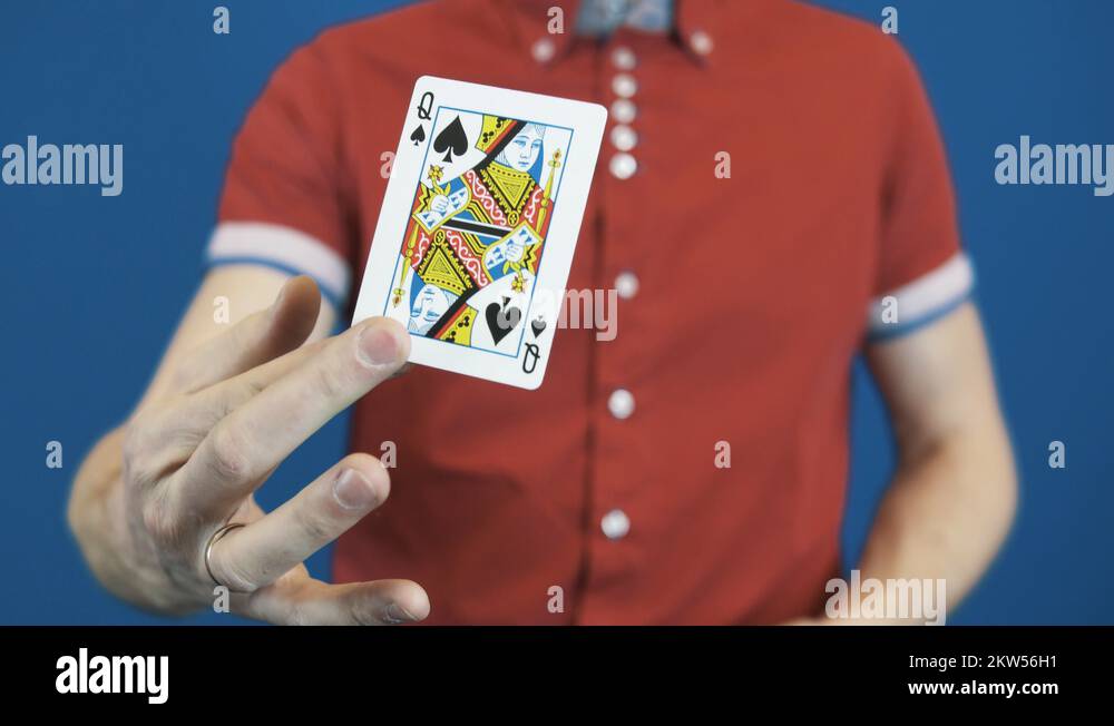 Close up magician in red shirt shuffle playing cards, show Queen of ...
