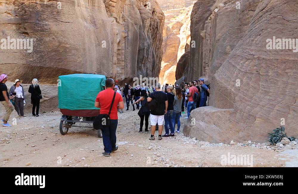 People in gorge that leads to Red Rose City Of Petra in Jordan Stock ...