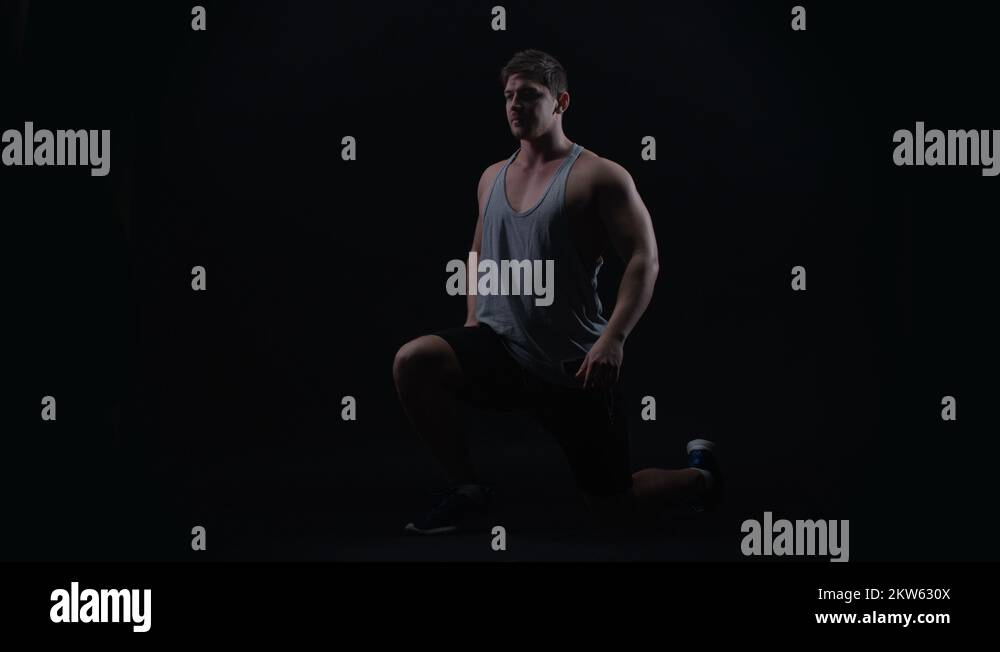 4K Fit young man with muscular physique doing stretches to improve ...