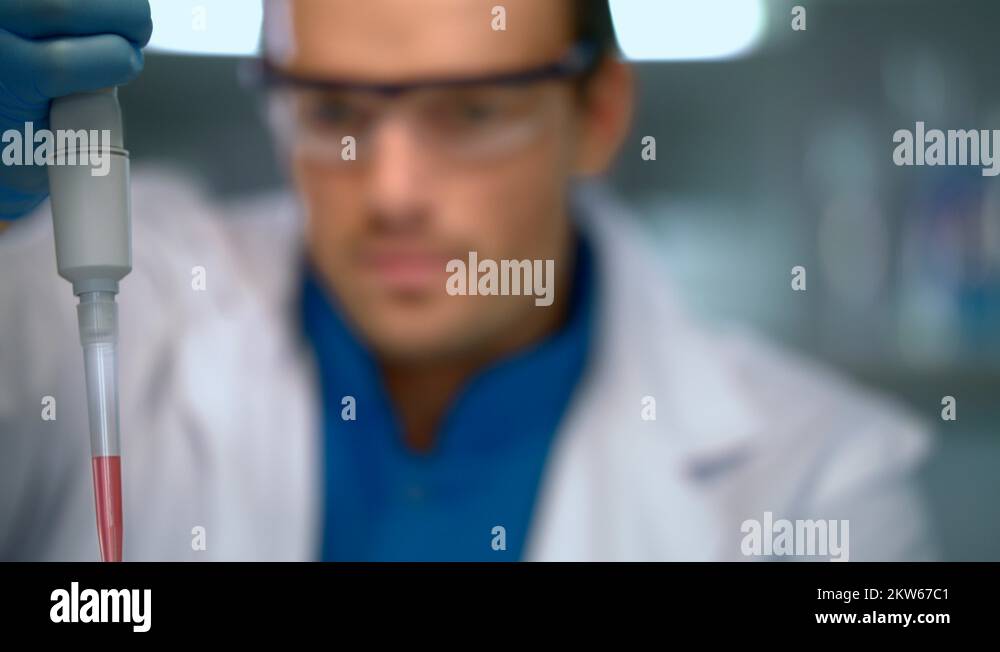 Doctor using micropipette in laboratory. Closeu up of scientist working ...