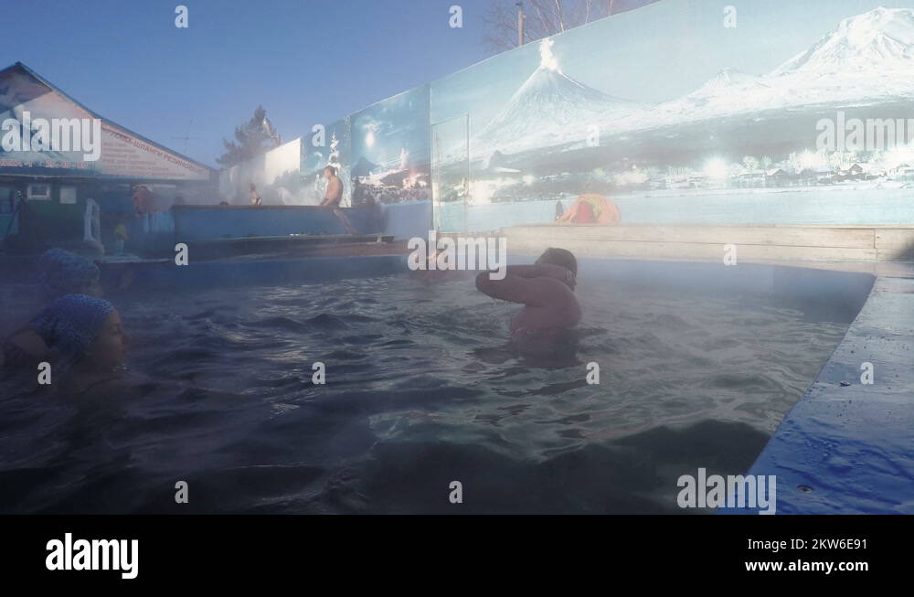 People bath in outdoor hot spring pool with natural thermal mineral ...