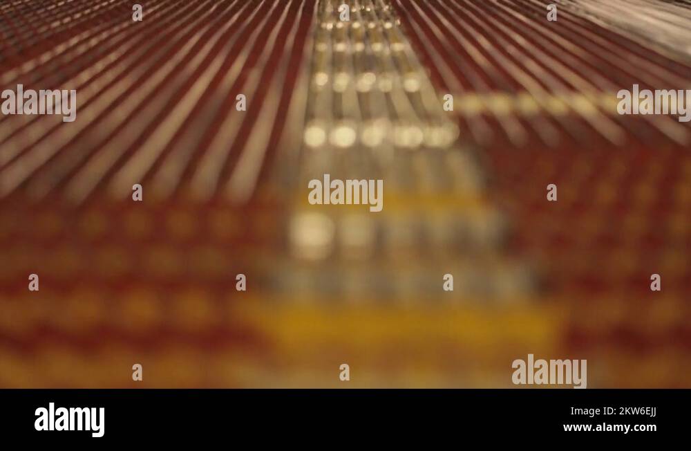 Reinforcing steel bars moving between zigzag rigs of the conveyer ...