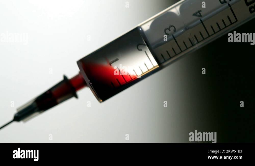 Mixing a drug with the blood in a syringe closeup Stock Video Footage ...