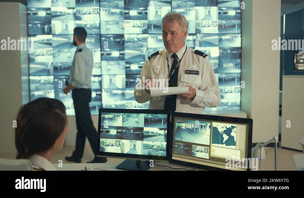 4K Security & surveillance team watching the screens in system control ...