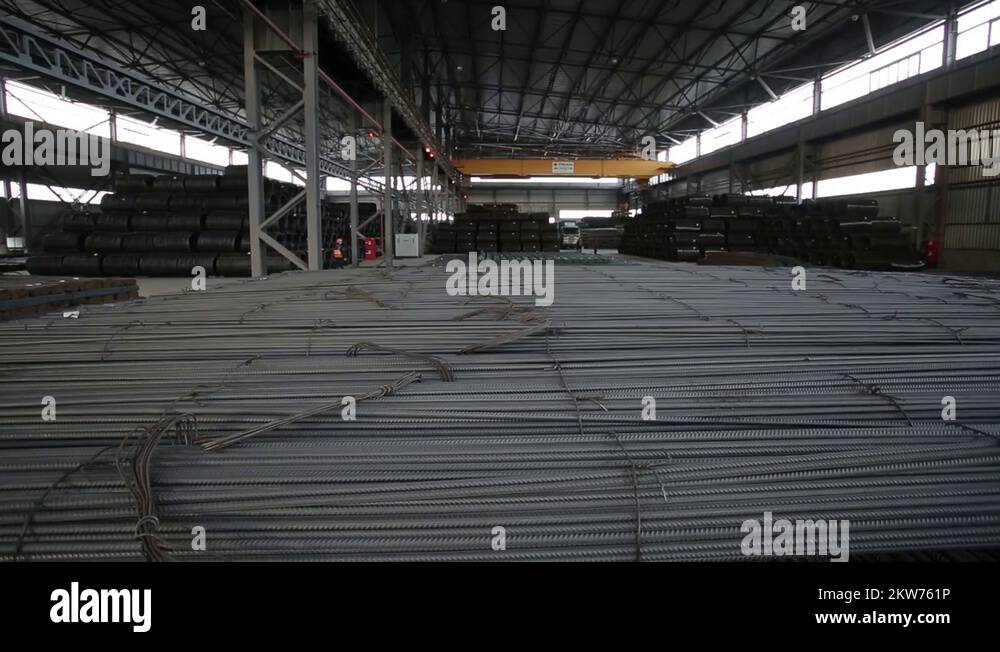 warehouse full of tied reinforcing steel bars right to left wide shot ...