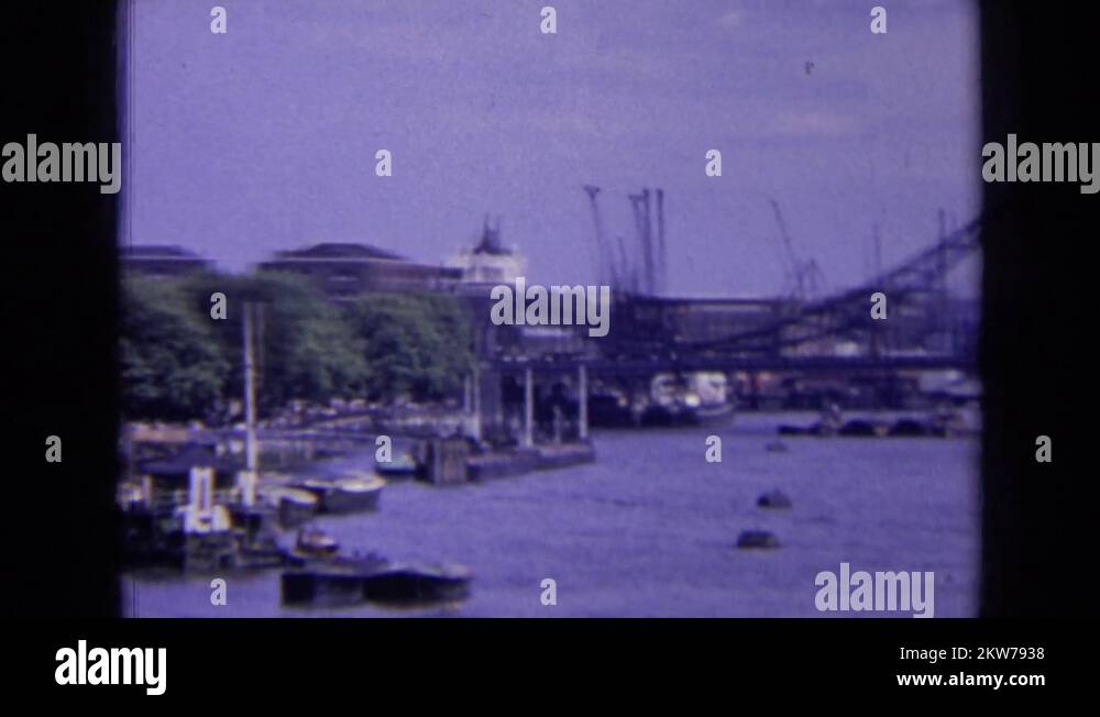 1963: panoramic view of london bridge and cranes lined up along thames ...