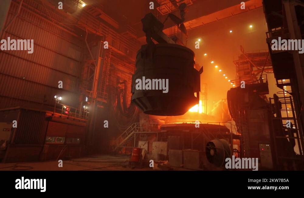 Huge vessel with melting iron moving inside the metallurgic plant Stock ...