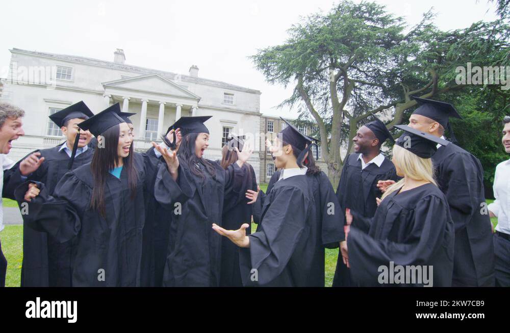4K Portrait happy students on graduation day outside university ...