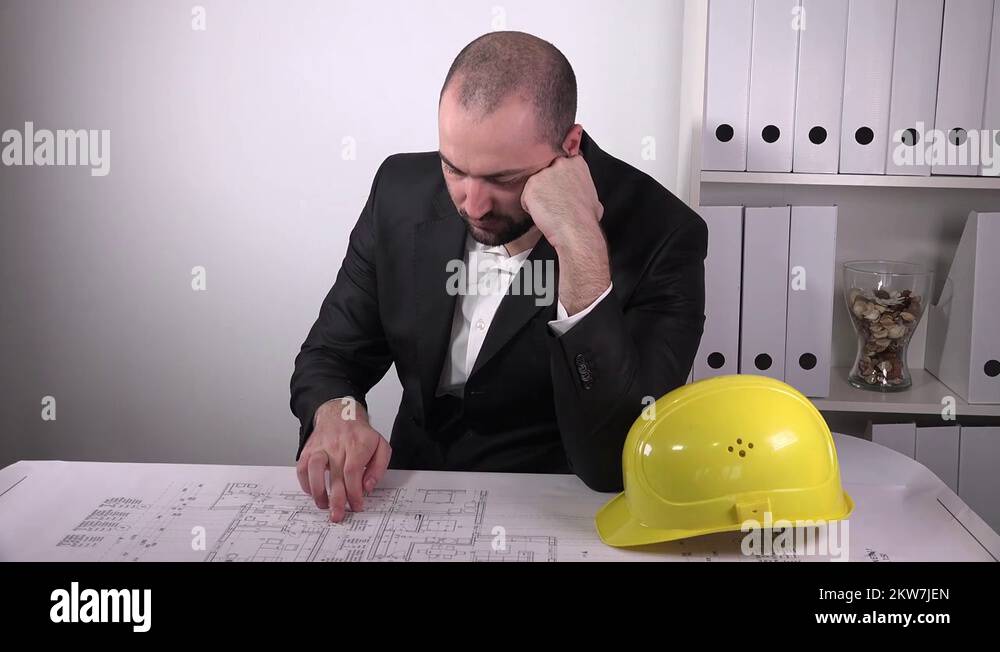 Sad upset architect finding errors blueprints building development ...