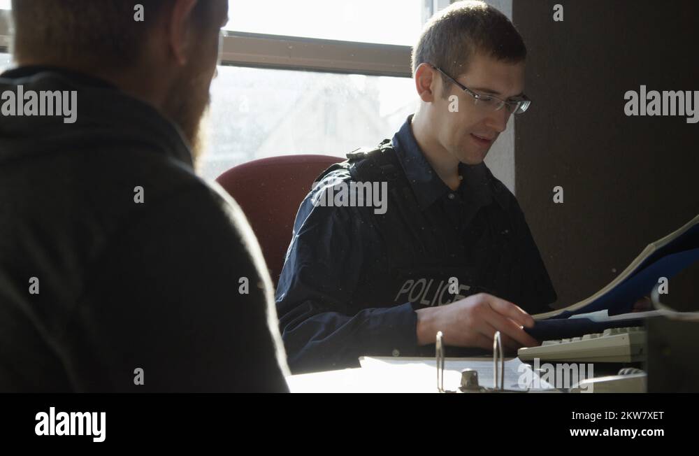 Police officer accusing suspect in precinct Stock Video Footage - Alamy