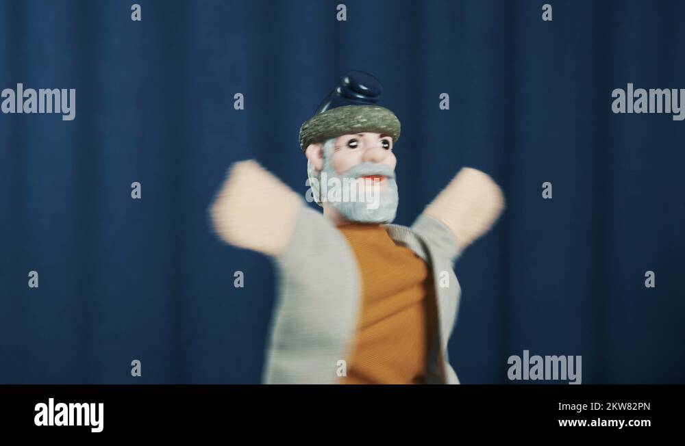 Aged man hand puppet make face palms in distress on scene with blue ...