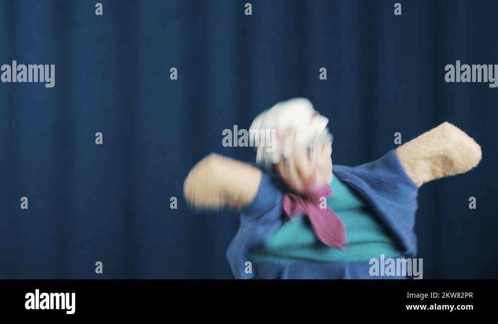 Old woman hand puppet appears on scene smooth dance movements on blue ...
