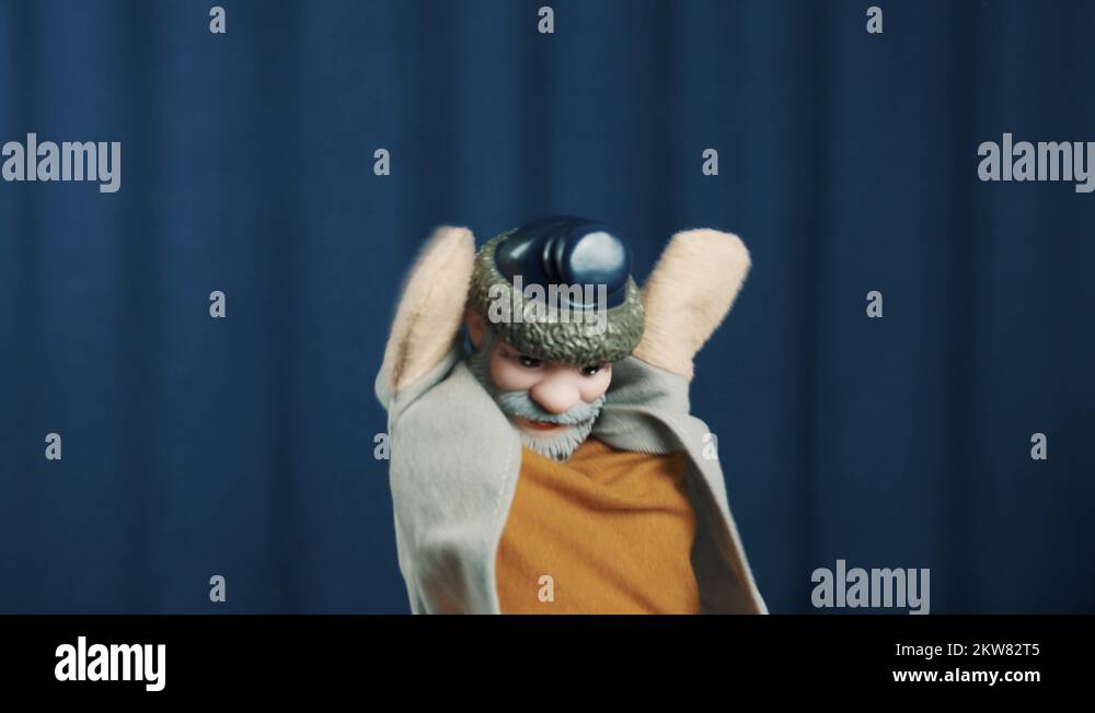 Peasant hand puppet make face palms in distress on scene with blue ...