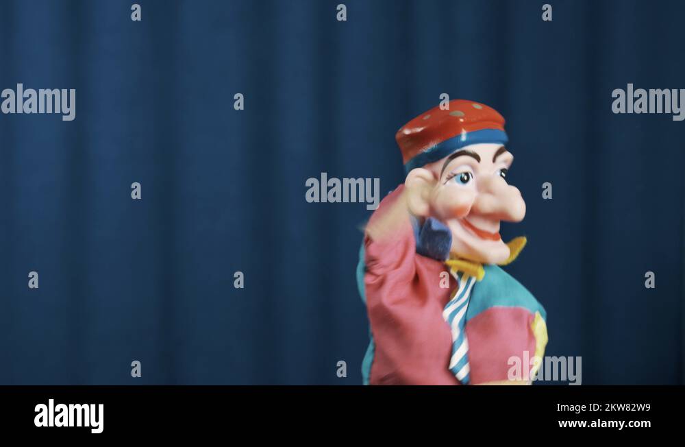 Petrushka hand puppet waving arm goodbye and walk off scene with blue ...