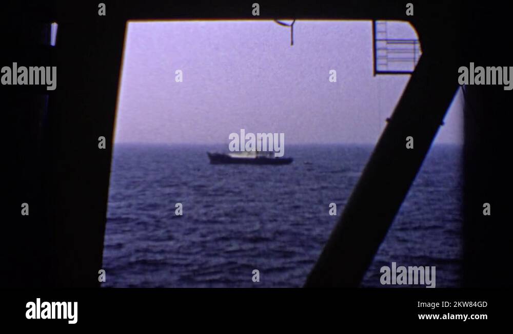 1970: a small vessel moving through the sea seen through window of a ...