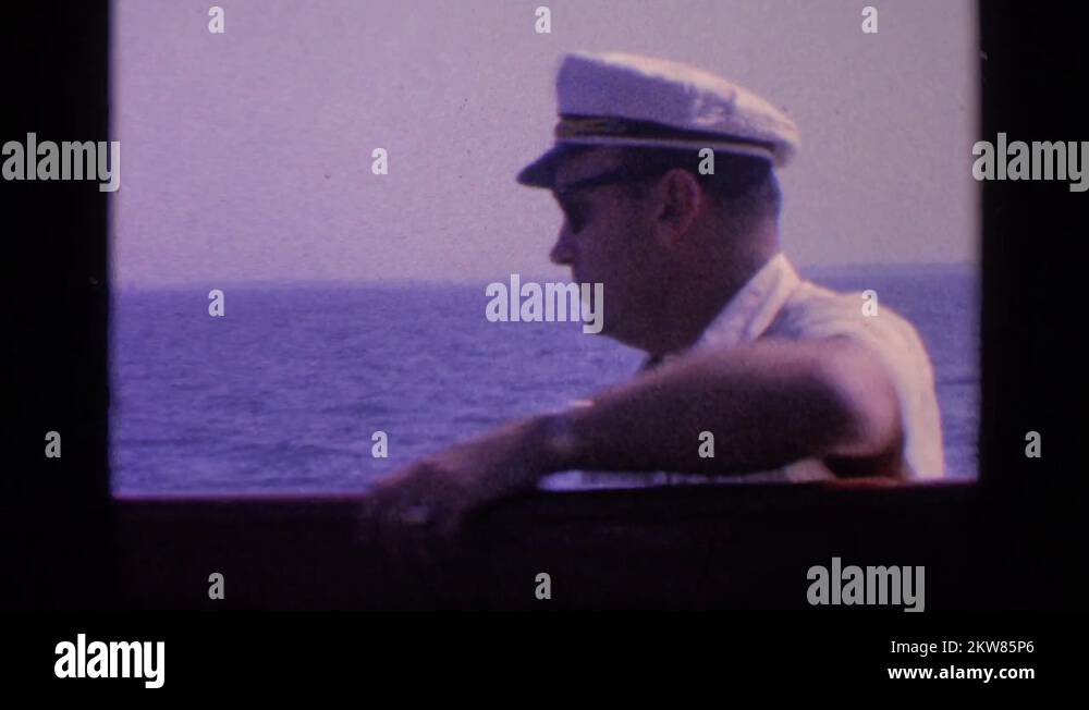 1968: a sailor on a boat walks gingerly while his son smiles at the ...