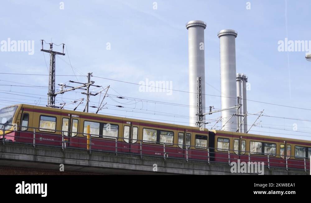 Morning in Berlin, U-Bahn train crosses overpass near industrial ...