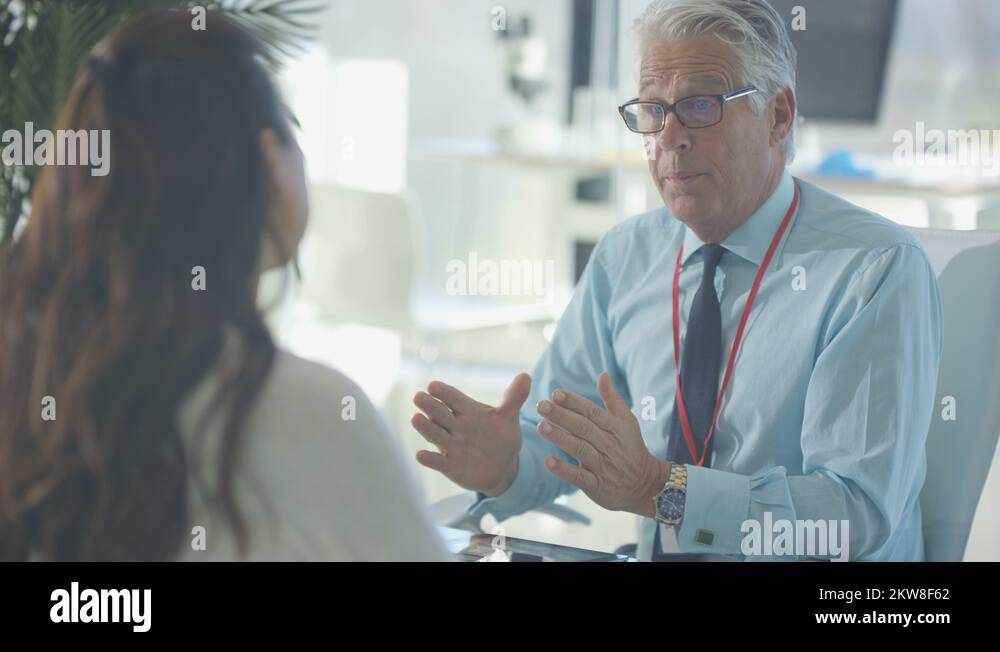 4K Audiology doctor with patient, showing her diagram of inner ear ...