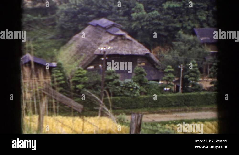 1953: road separates low buildings with wide roofs from divided farm ...