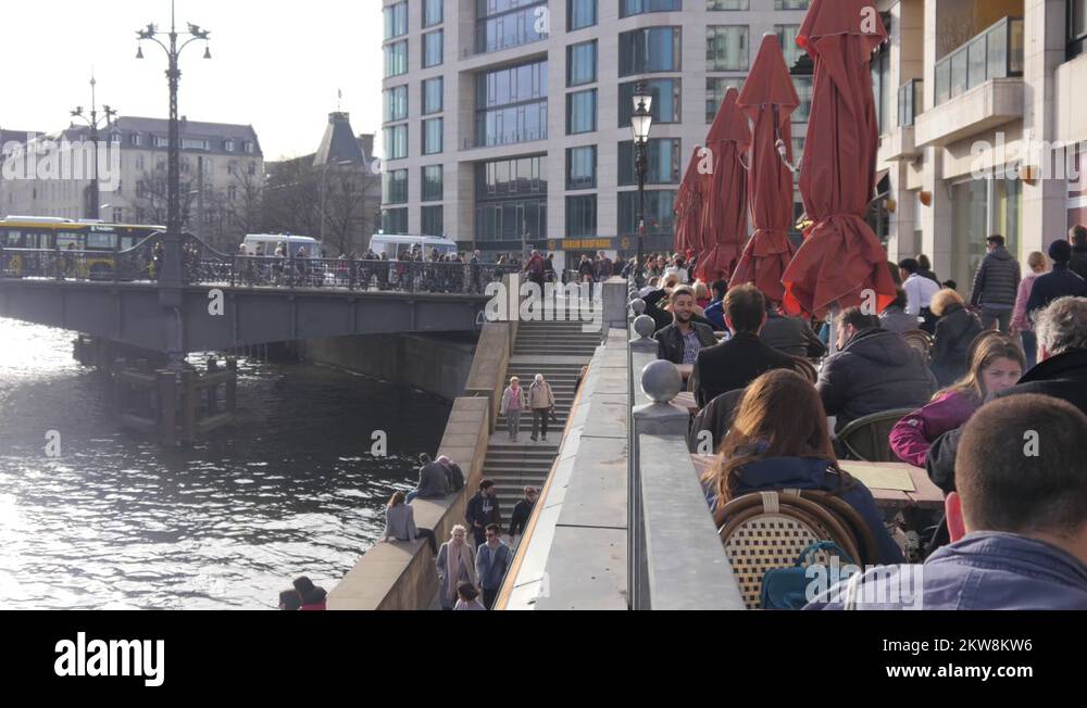 Berlin river Spree embankment people tourists walk and sit at street ...