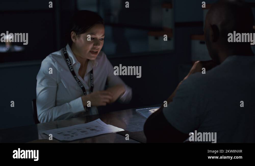 4K Female police detective questioning a crime suspect & showing him ...