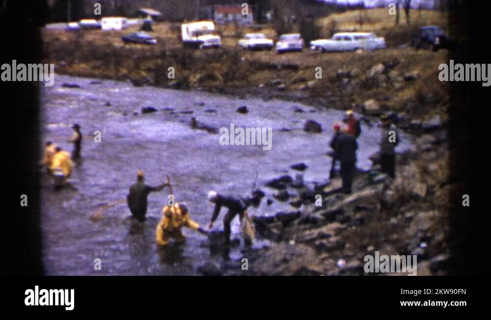 1961: people with yellow uniform and normal dressed people fishing in ...