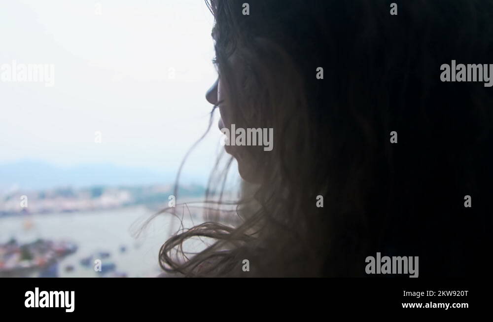 Girl standing at the window close-up Stock Video Footage - Alamy