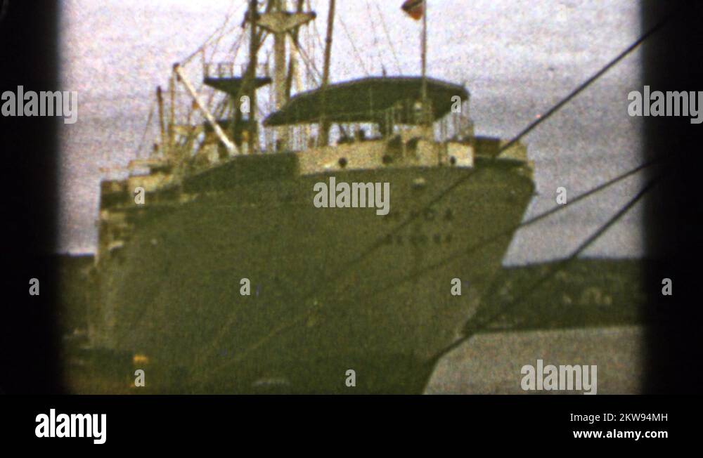 1965: a large shaped,sharp edged boat standing on harbor tied by with ...