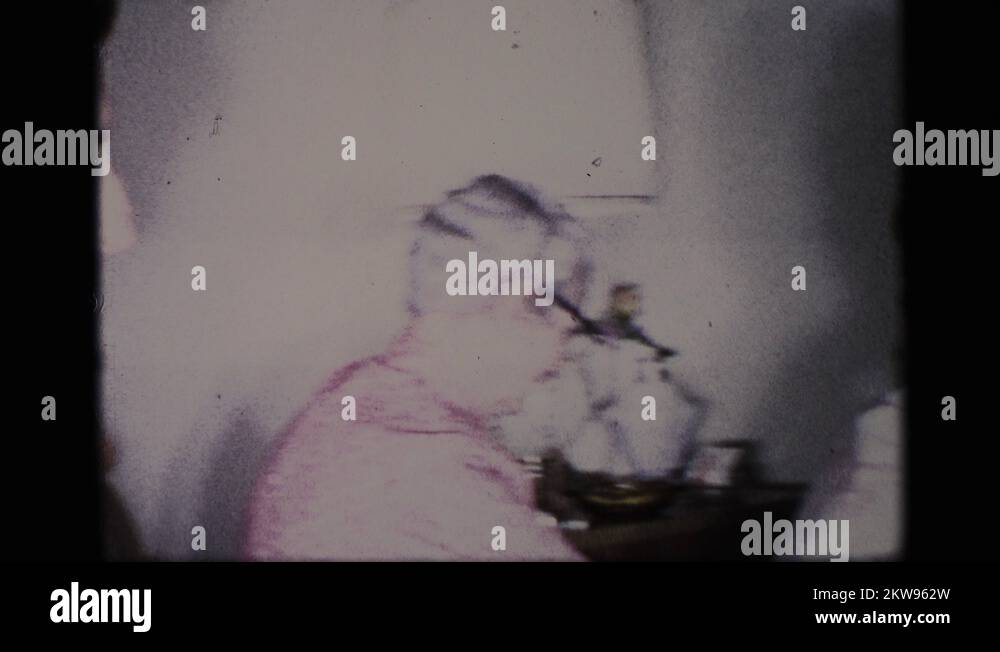 1959: family get together, women are giving dress to their child, a fun ...