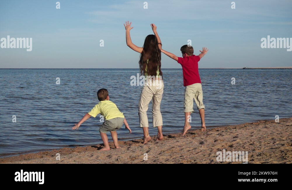 Group of three kids jumping at the beach in Egypt resort, slow m Stock ...