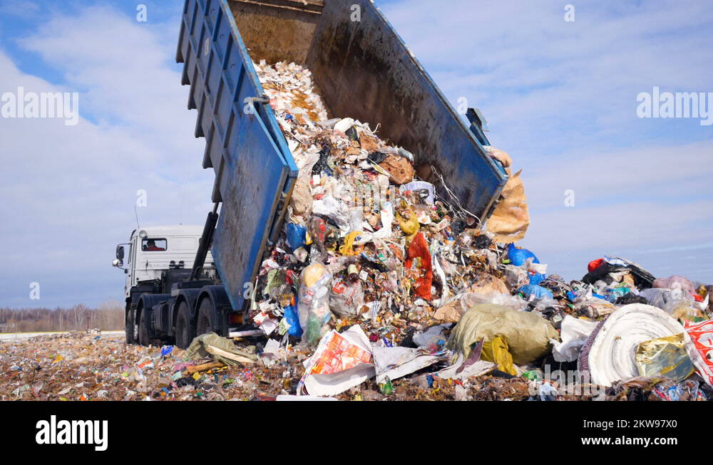 Garbage truck disposed trash on the landfill. Vehicle transporting ...