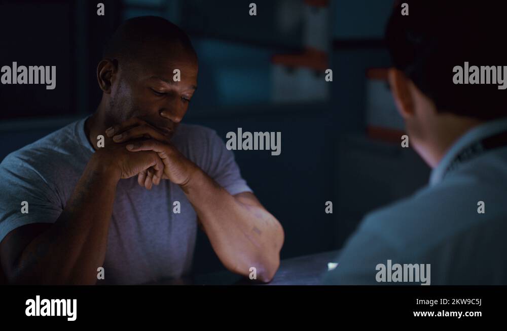 4K Crime suspect being questioned by police officer in interrogation ...