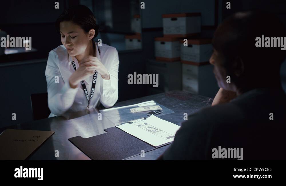 4K Female police detective questioning a crime suspect in interrogation ...