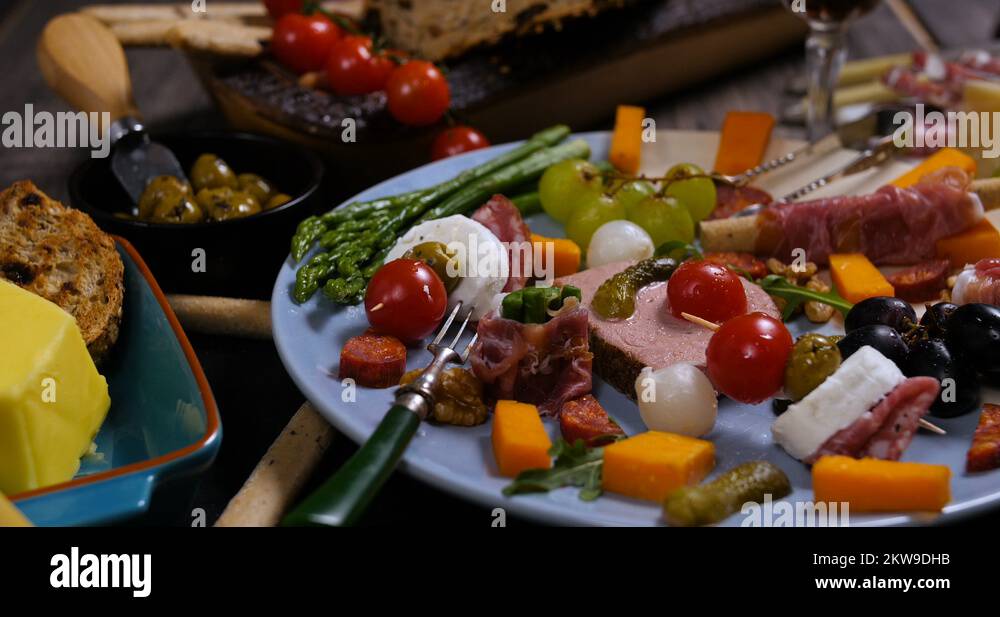 A platter of cured meat (charcuterie), ham, salami, pate and cheese ...