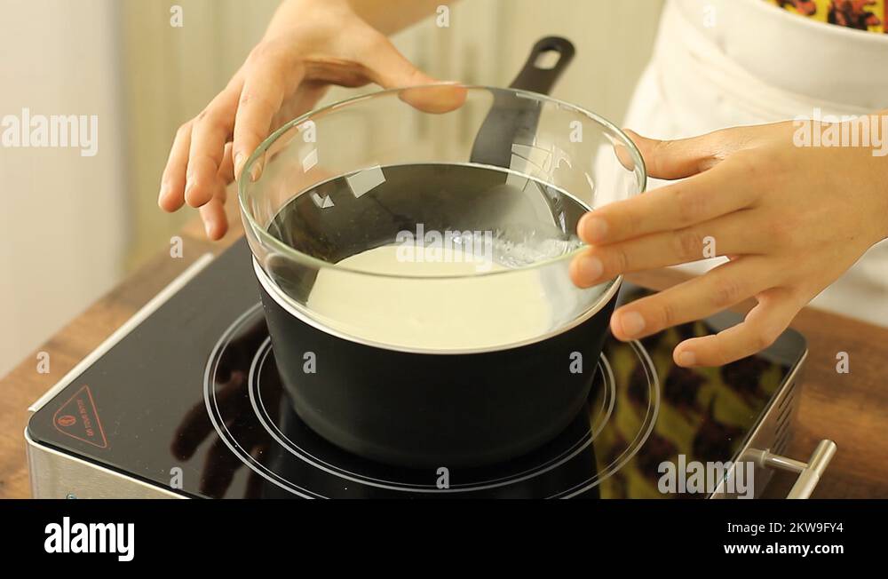 Food Chocolate Chef melted chocolate bar in Bain marie with cream Stock ...