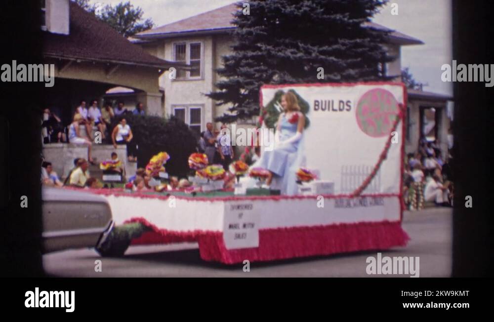 1969: people riding down the road in a parade atop floats while being ...