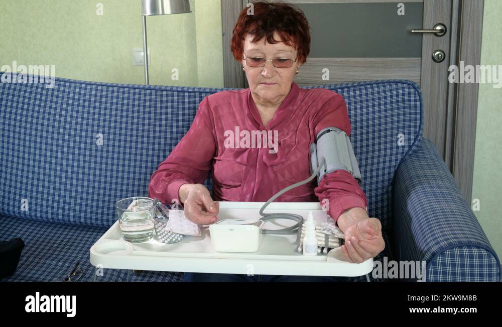 Mature lady examining her health state with manometer Stock Video ... Mature lady examining her health state with manometer Stock Video ...