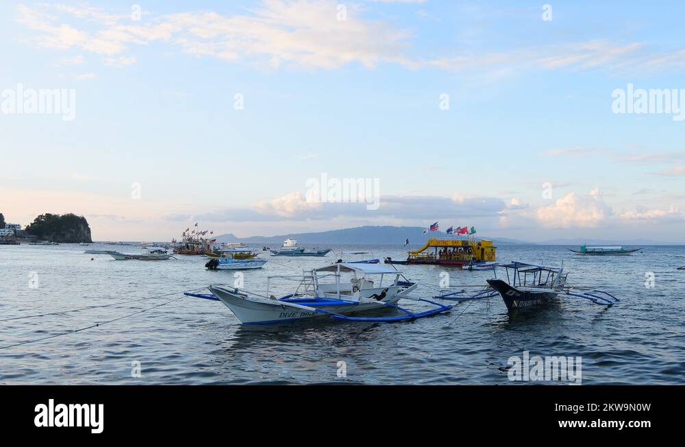 Traditional filipino outriggers on the ocean during sunet in the ...