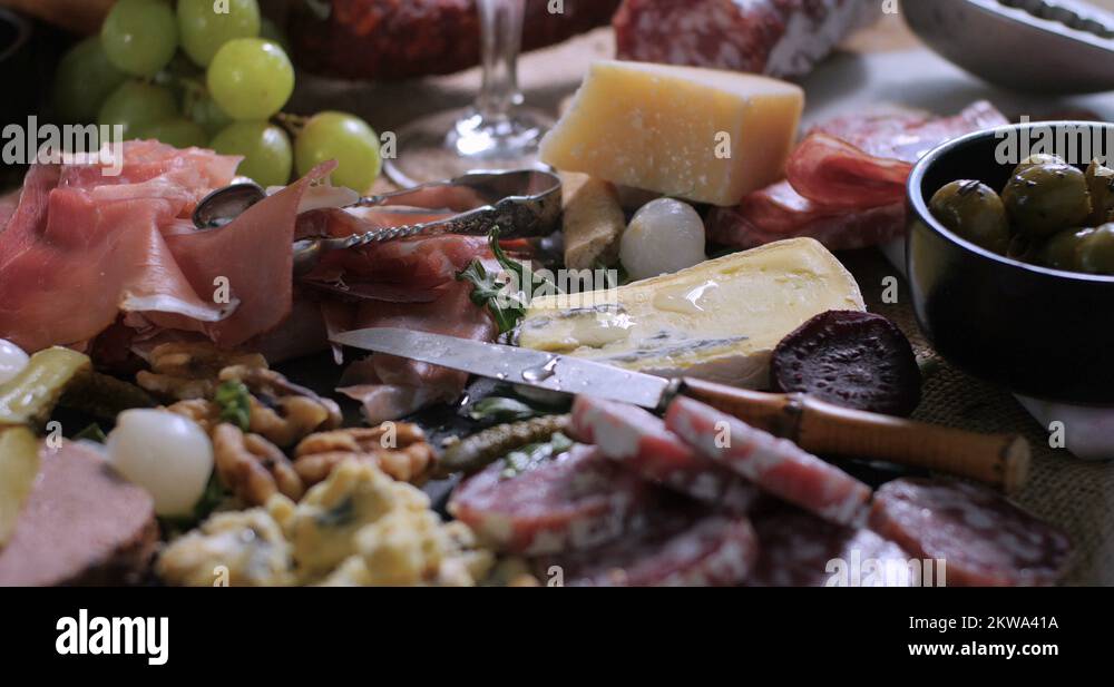 A platter of cured meat (charcuterie), ham, salami, pate and cheese ...